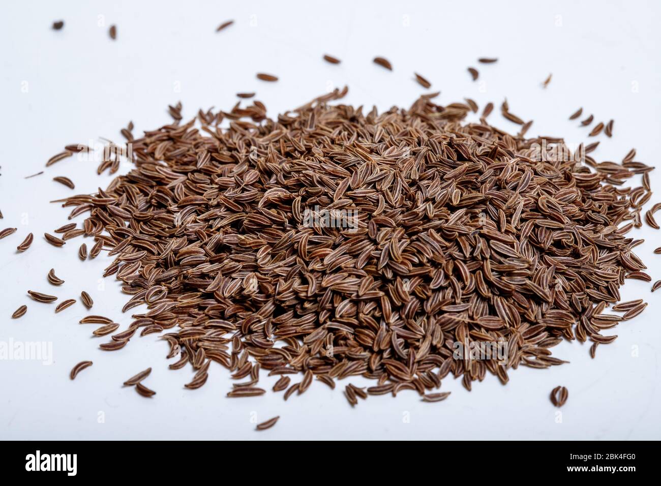 Pile of cumin seeds isolated on white background Stock Photo - Alamy