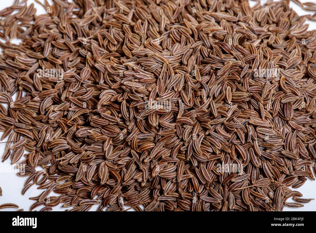 Pile of cumin seeds isolated on white background Stock Photo - Alamy