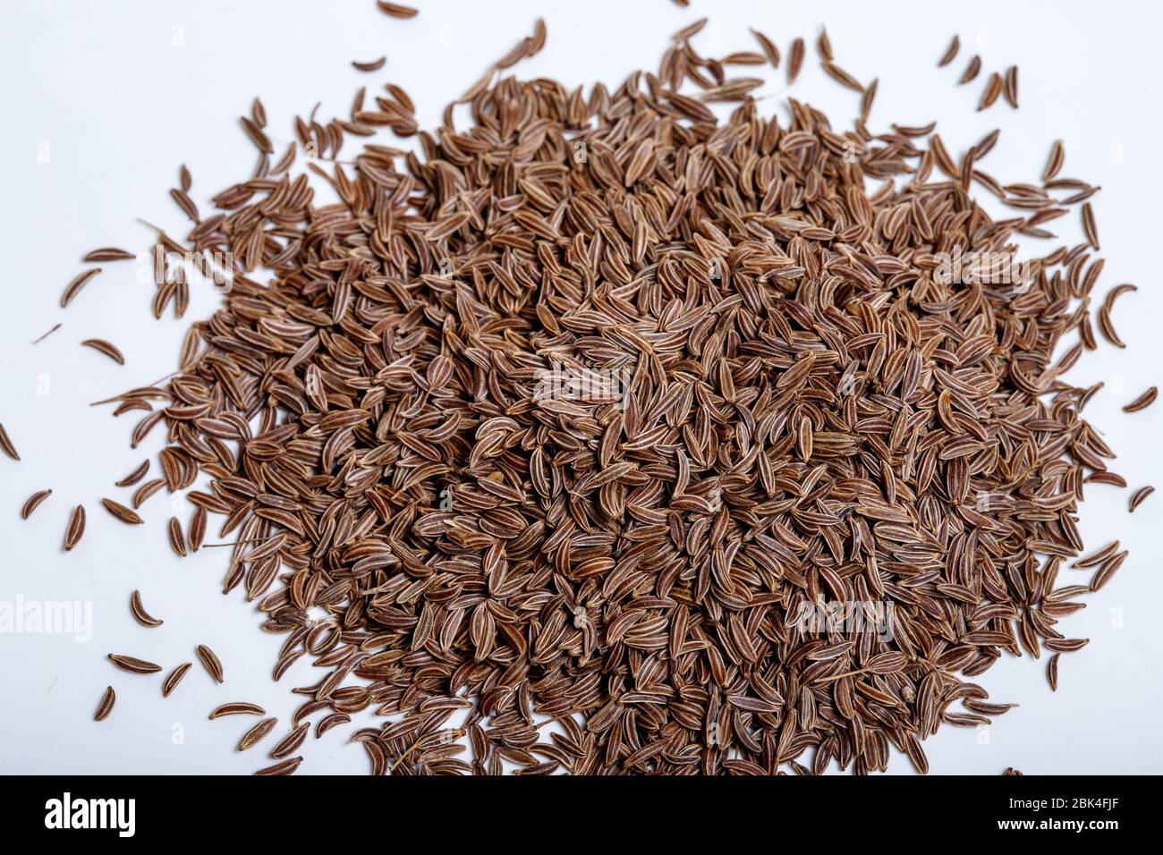 Pile of cumin seeds isolated on white background Stock Photo - Alamy