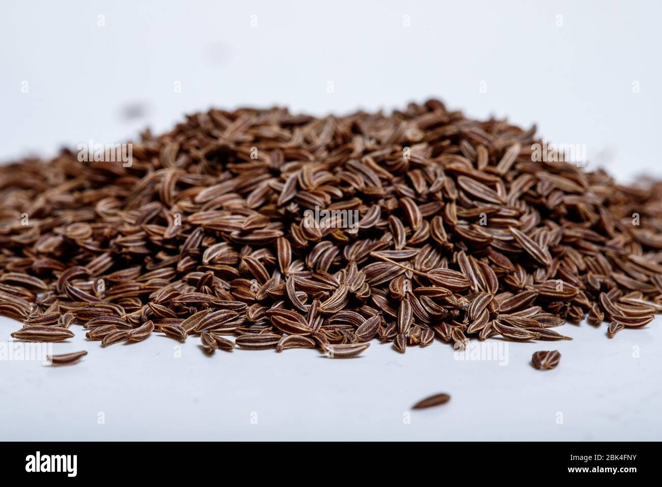 Pile of cumin seeds isolated on white background Stock Photo - Alamy