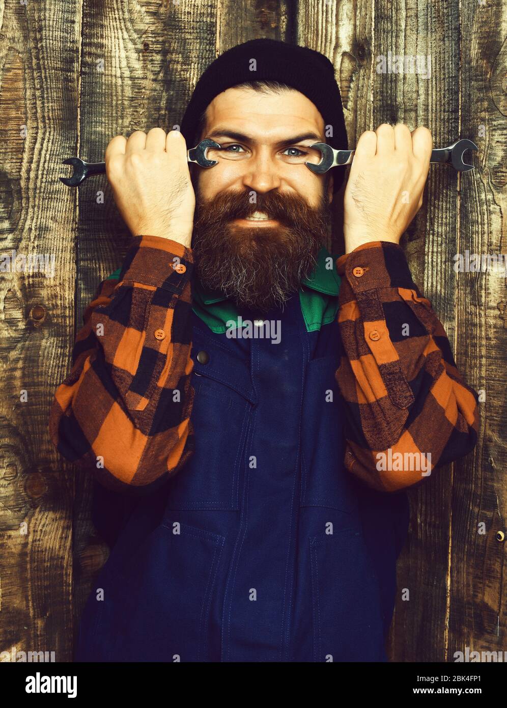 Bearded man, long beard. Brutal caucasian mechanic, smiling happy ...