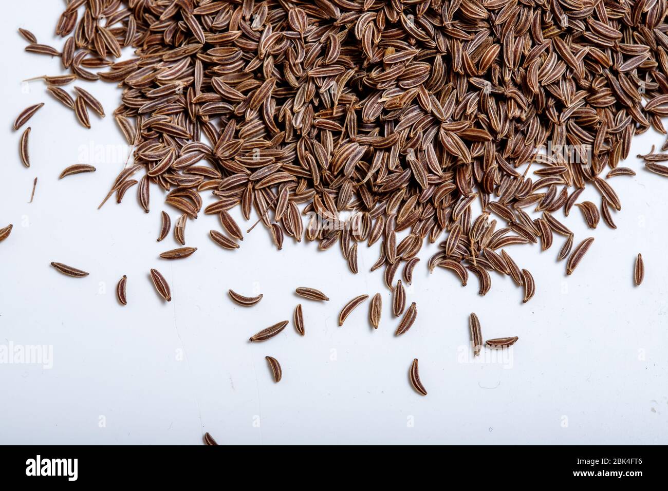 Pile of cumin seeds isolated on white background Stock Photo - Alamy