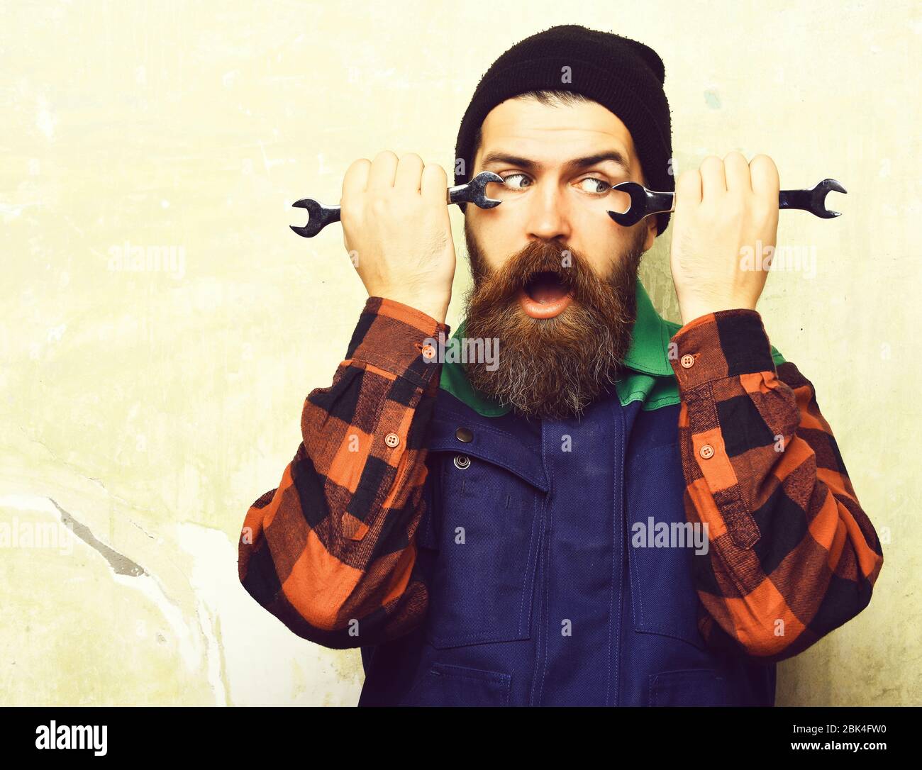 Bearded man, long beard. Brutal caucasian mechanic, surprised unshaven ...