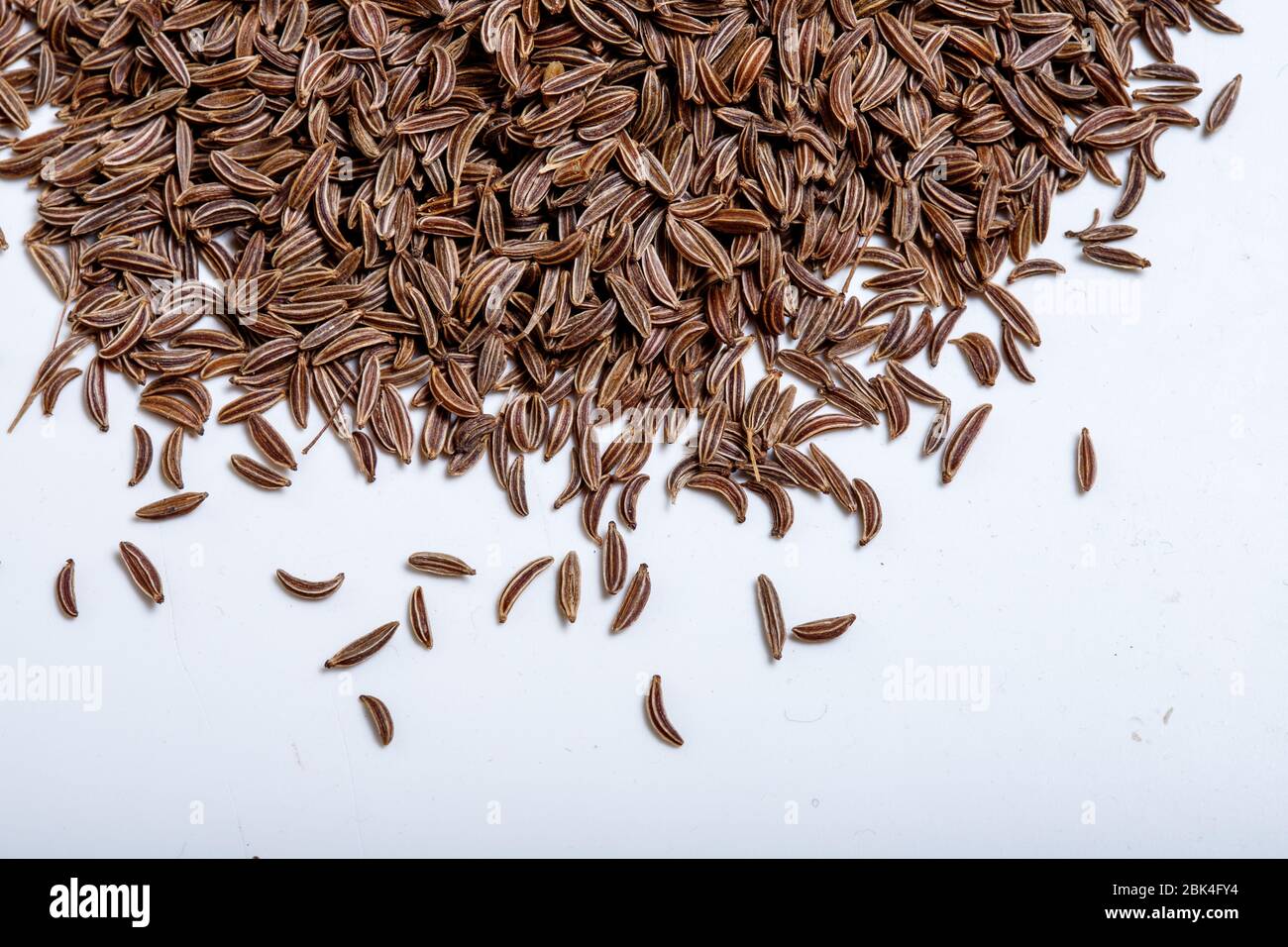 Pile of cumin seeds isolated on white background Stock Photo - Alamy