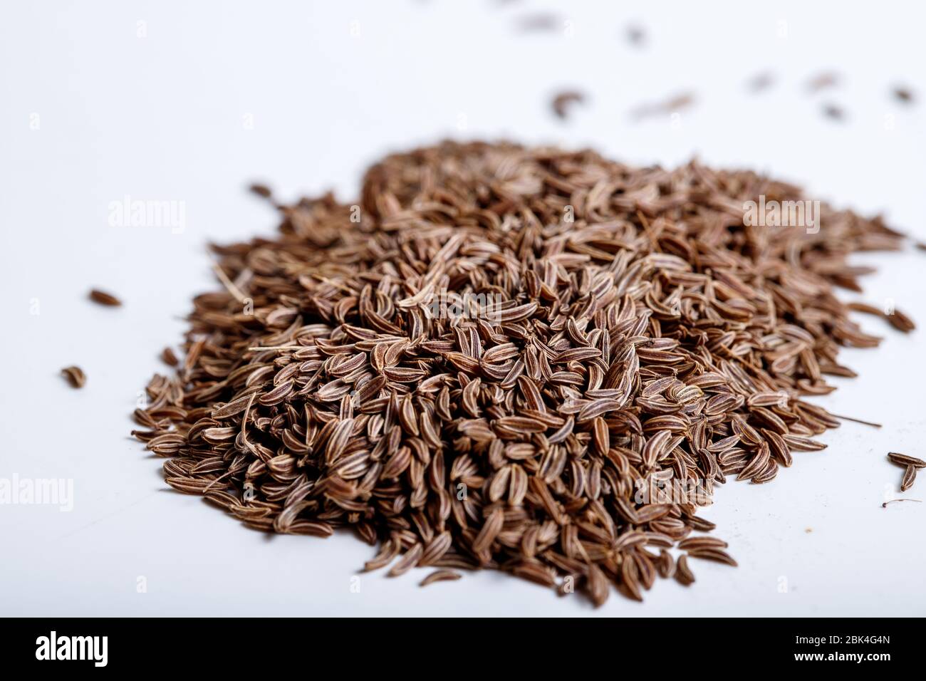 Pile of cumin seeds isolated on white background Stock Photo - Alamy