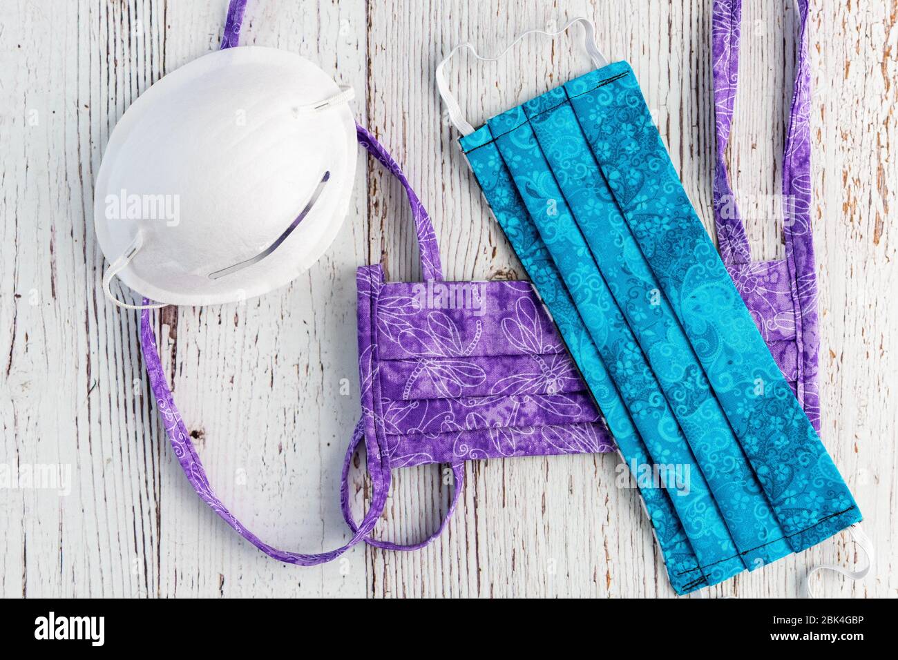 Handmade blue and purple fabric protective face masks, and white ...