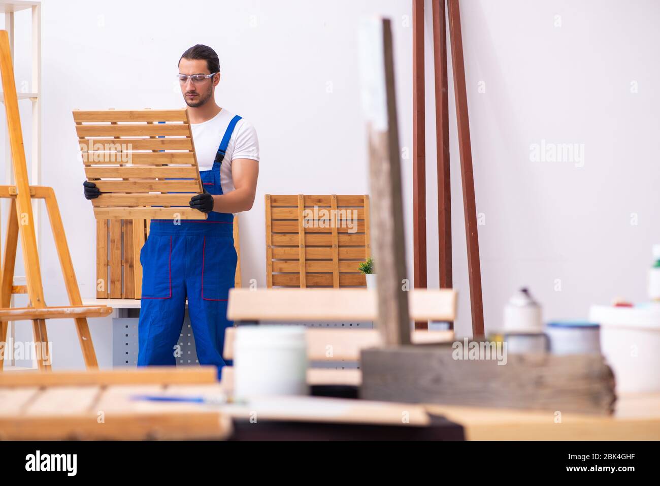 Young male contractor working in the workshop Stock Photo - Alamy