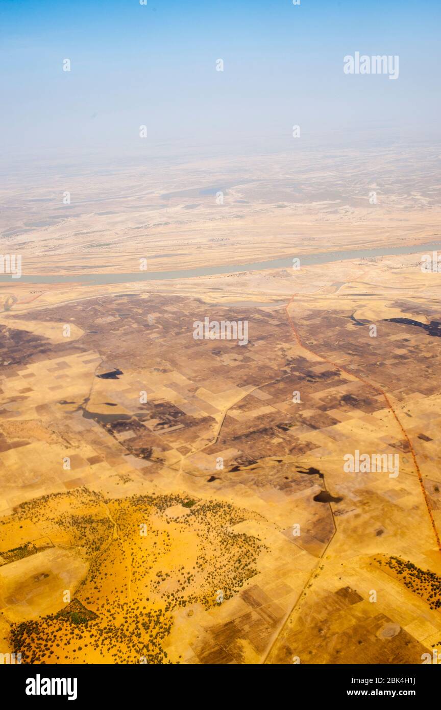Aerial view of the dry Sub-Saharan landscapes with fields and the Niger ...