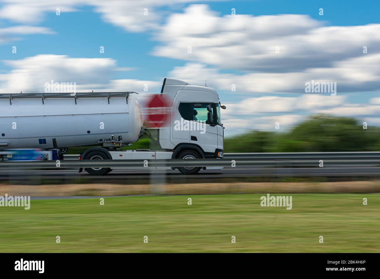 Tank truck driving on the highway with all the landscape moved creating ...