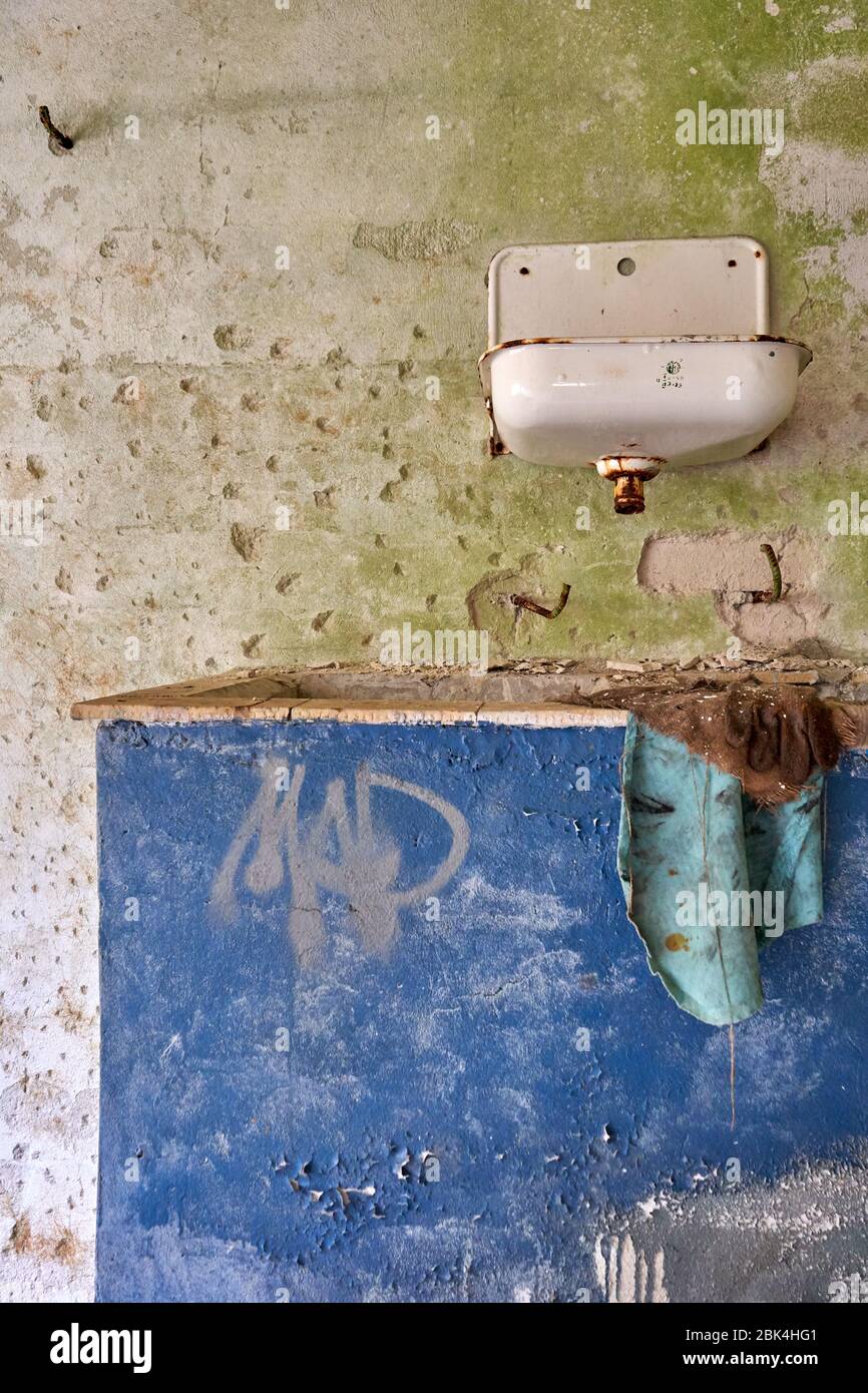 Inside of old abandoned building. Sink is hanging very high Stock Photo ...