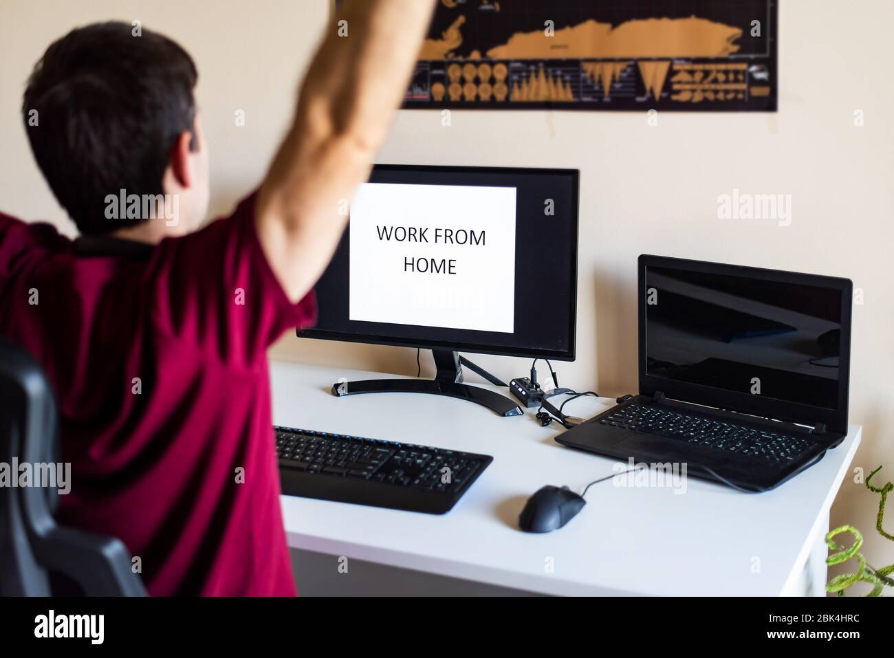 Man stretching while working from home in an improvised office in the ...