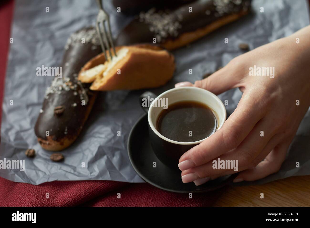 Woman eating chocolate eclair hi-res stock photography and images - Alamy