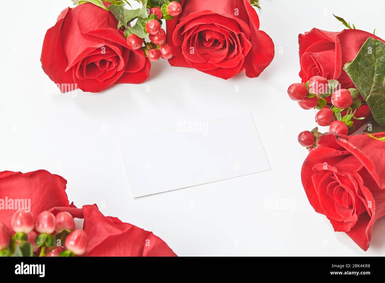 Paper card and bouquet of roses isolated on white background Stock ...