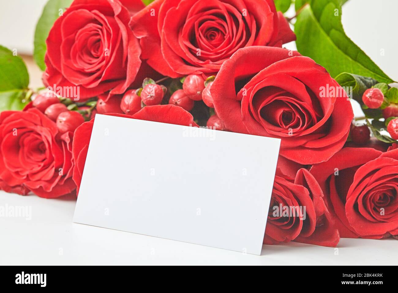 Paper card and bouquet of roses isolated on white background Stock ...