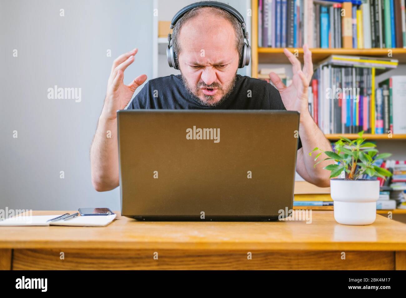 Man working from home office, angry face expression. Adult bearded man ...
