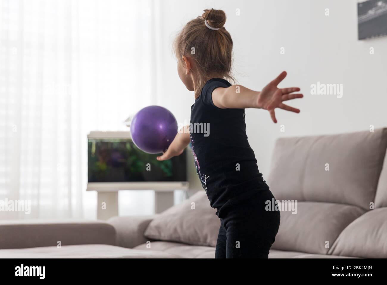 Girl gymnast performs exercises with the ball Stock Photo - Alamy