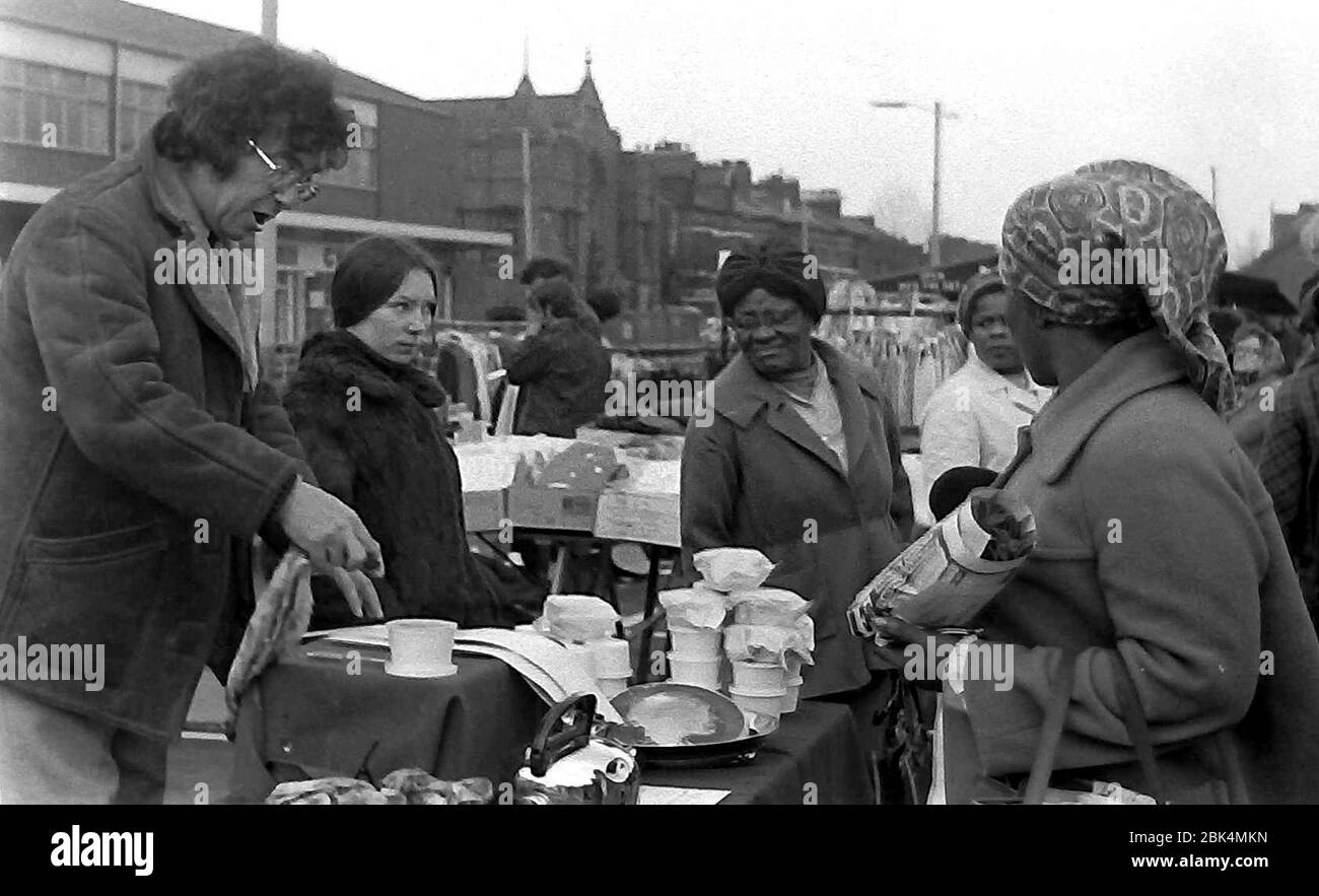 Customers look at a stall outdoors on Longsight Market, Dickenson Road ...