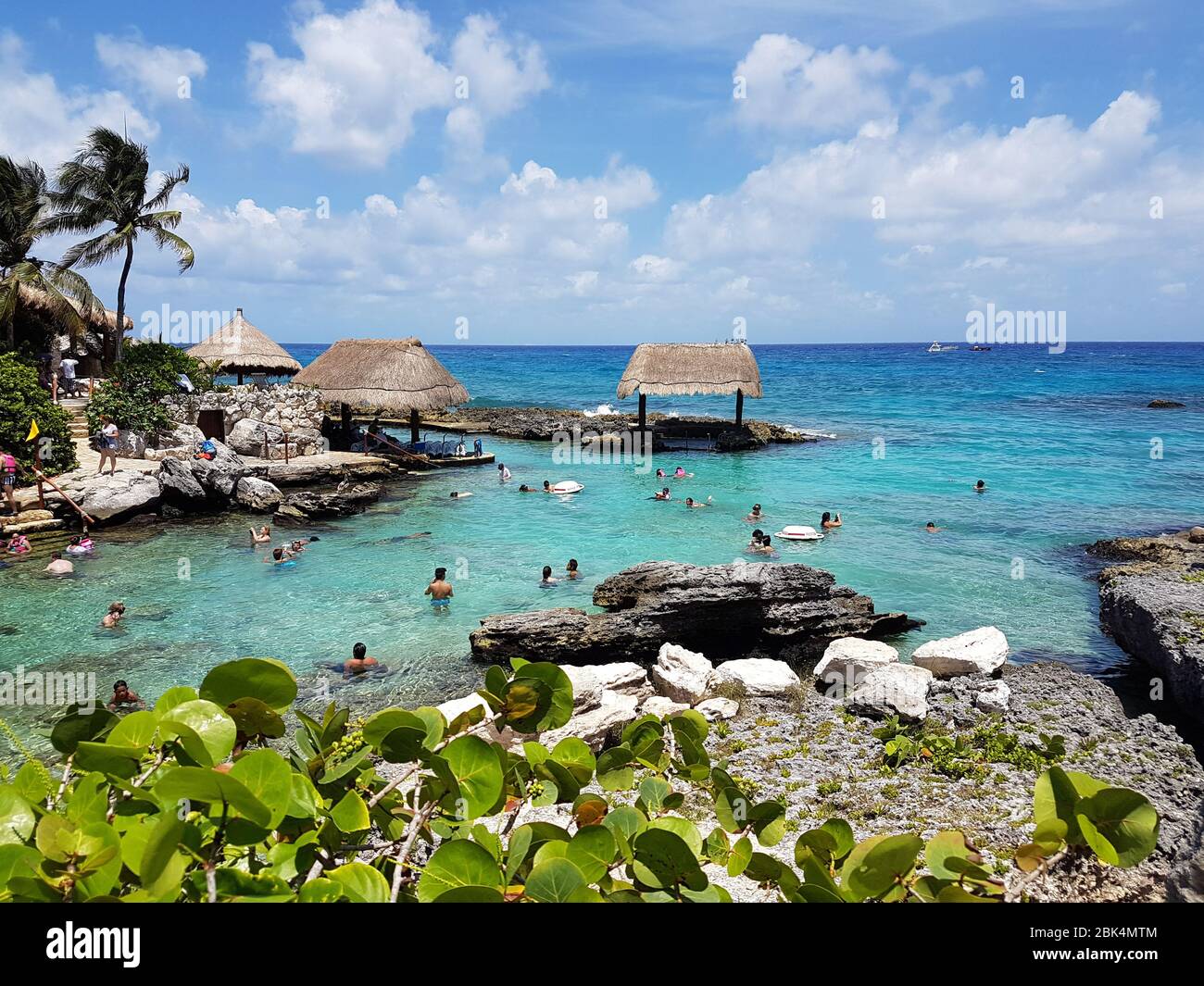 tropical pool bar with families enjoying their vacation at a Caribbean ...
