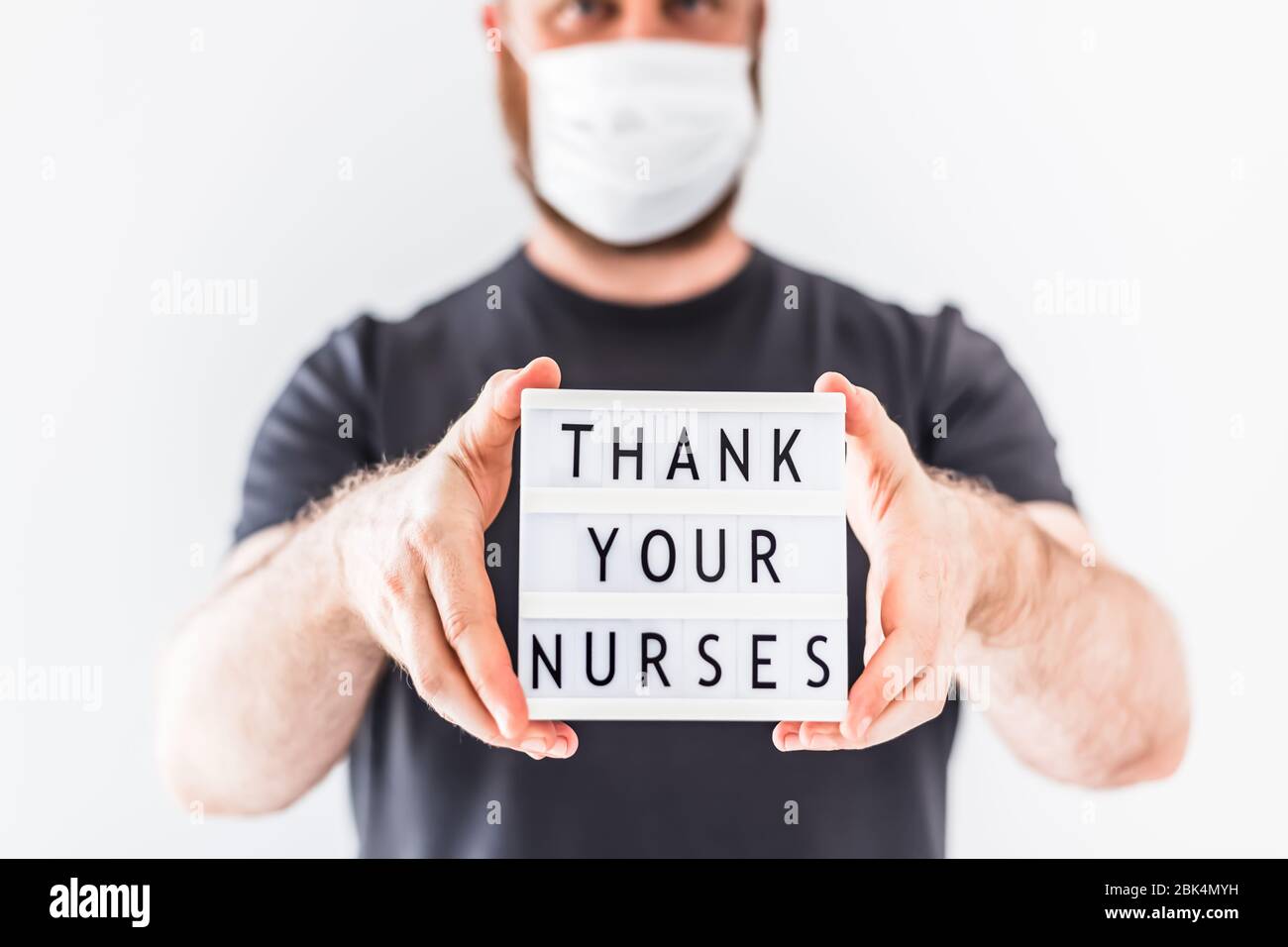 Nurse day concept. Man hands holding lightbox with text Thank your ...