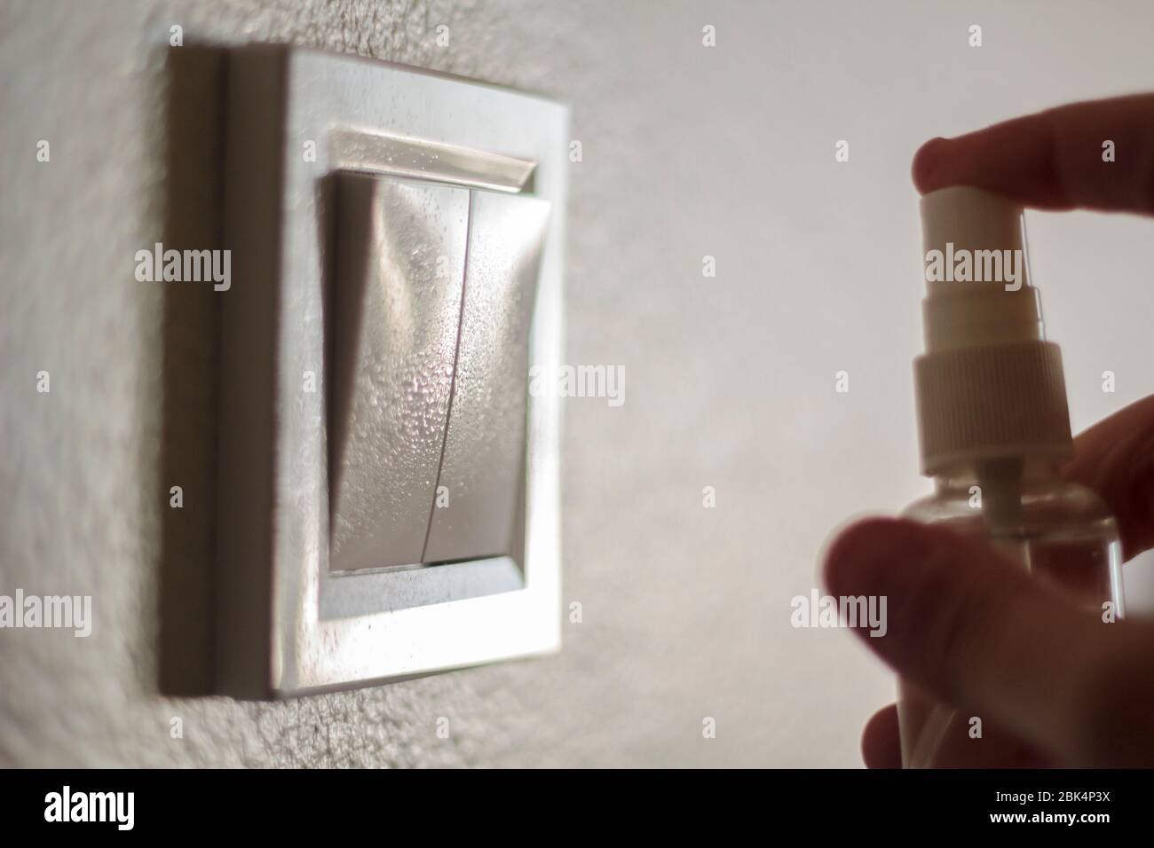 Clean and disinfect light switch with alcohol. Germs, bacteria, Covid ...