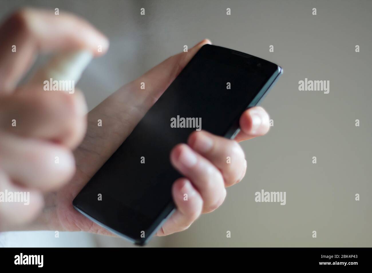 Clean and disinfect mobile phone with alcohol. Germs, bacteria, Covid ...