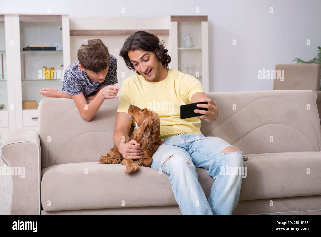 Young father and son with cocker spaniel dog Stock Photo - Alamy
