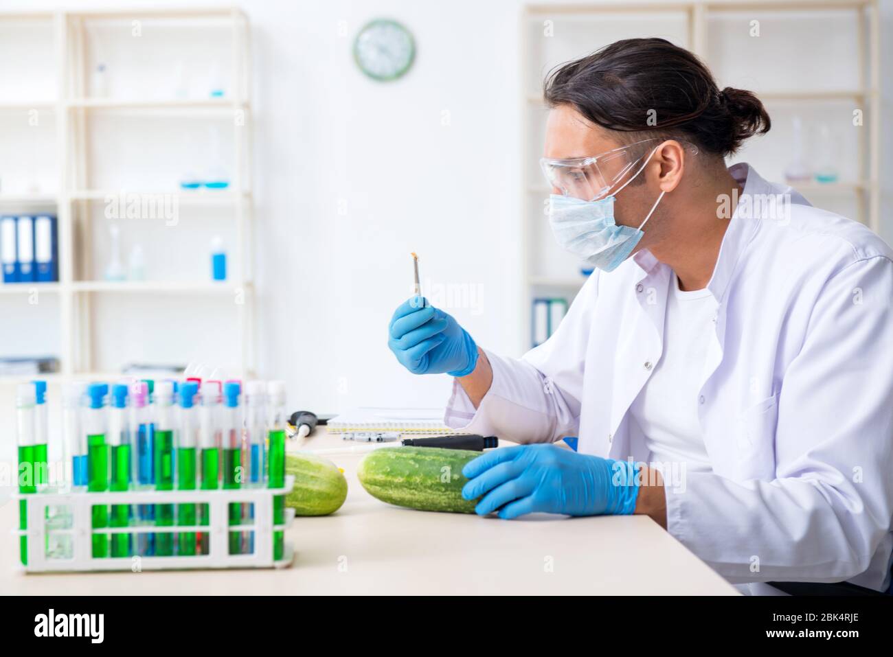 The male nutrition expert testing vegetables in lab Stock Photo - Alamy