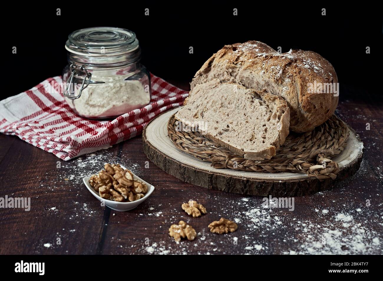 Rustic homemade round bread stuffed with walnuts and home baked in the ...