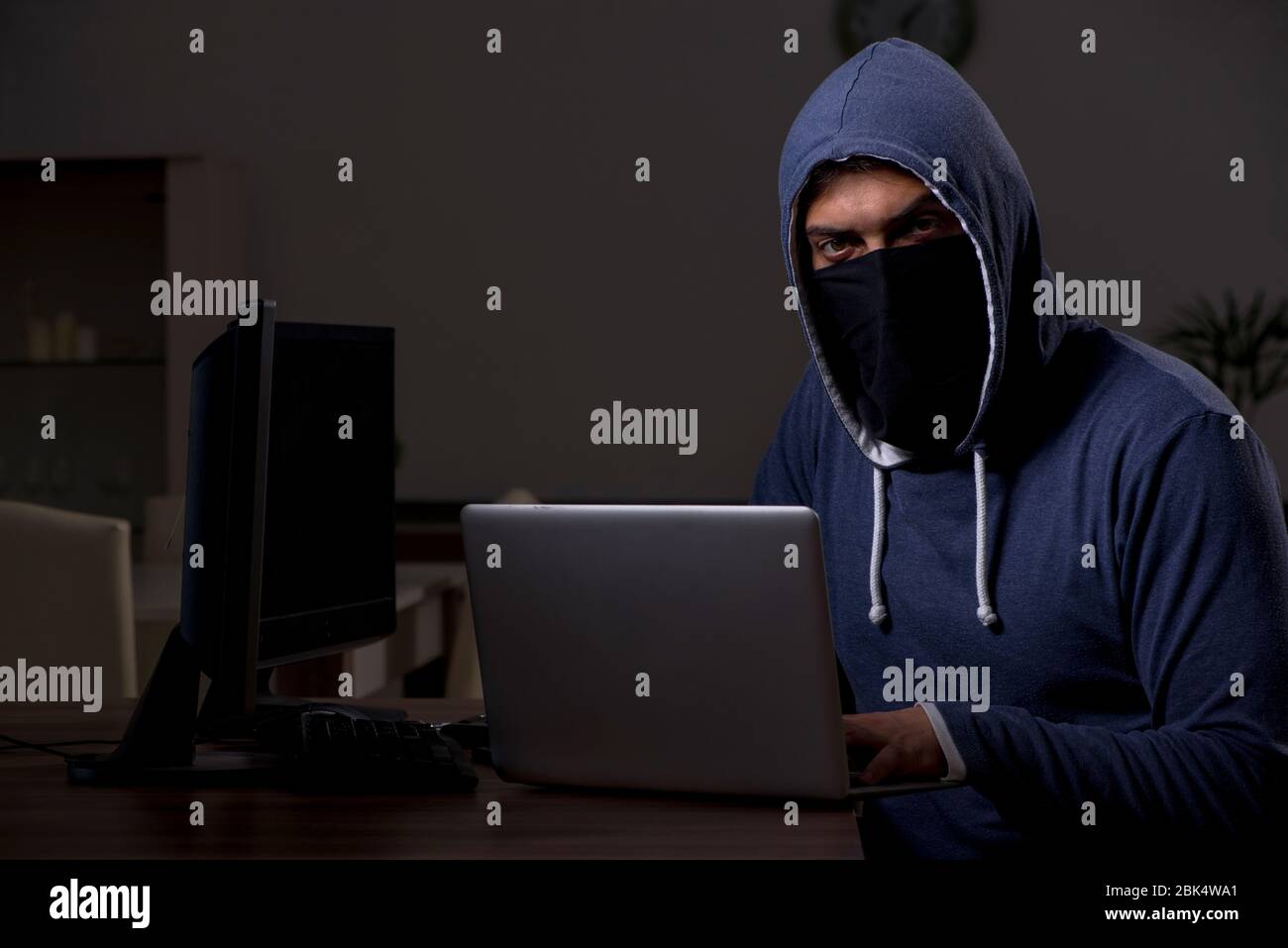 Male hacker hacking security firewall late in the office Stock Photo ...