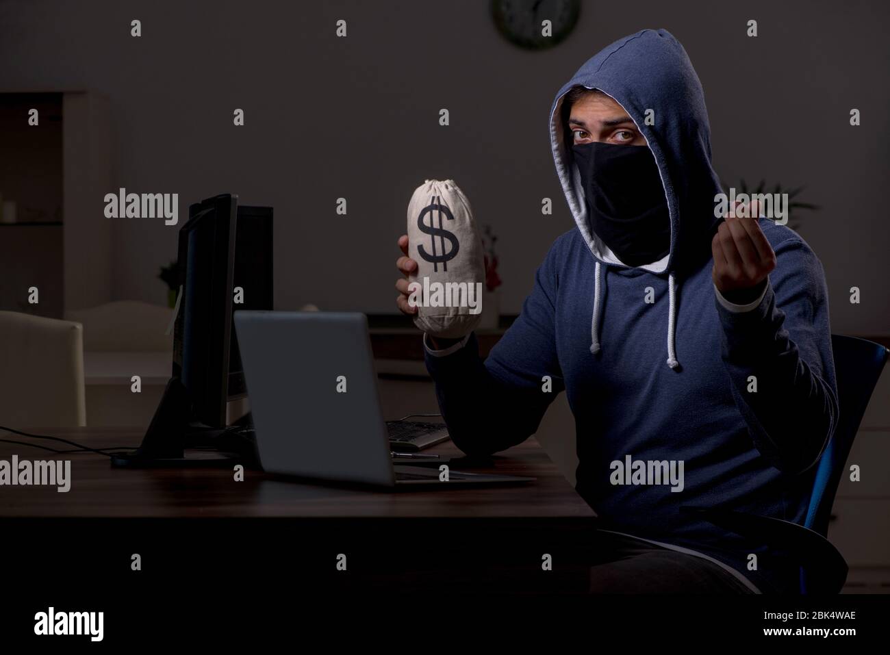 Male hacker hacking security firewall late in the office Stock Photo ...