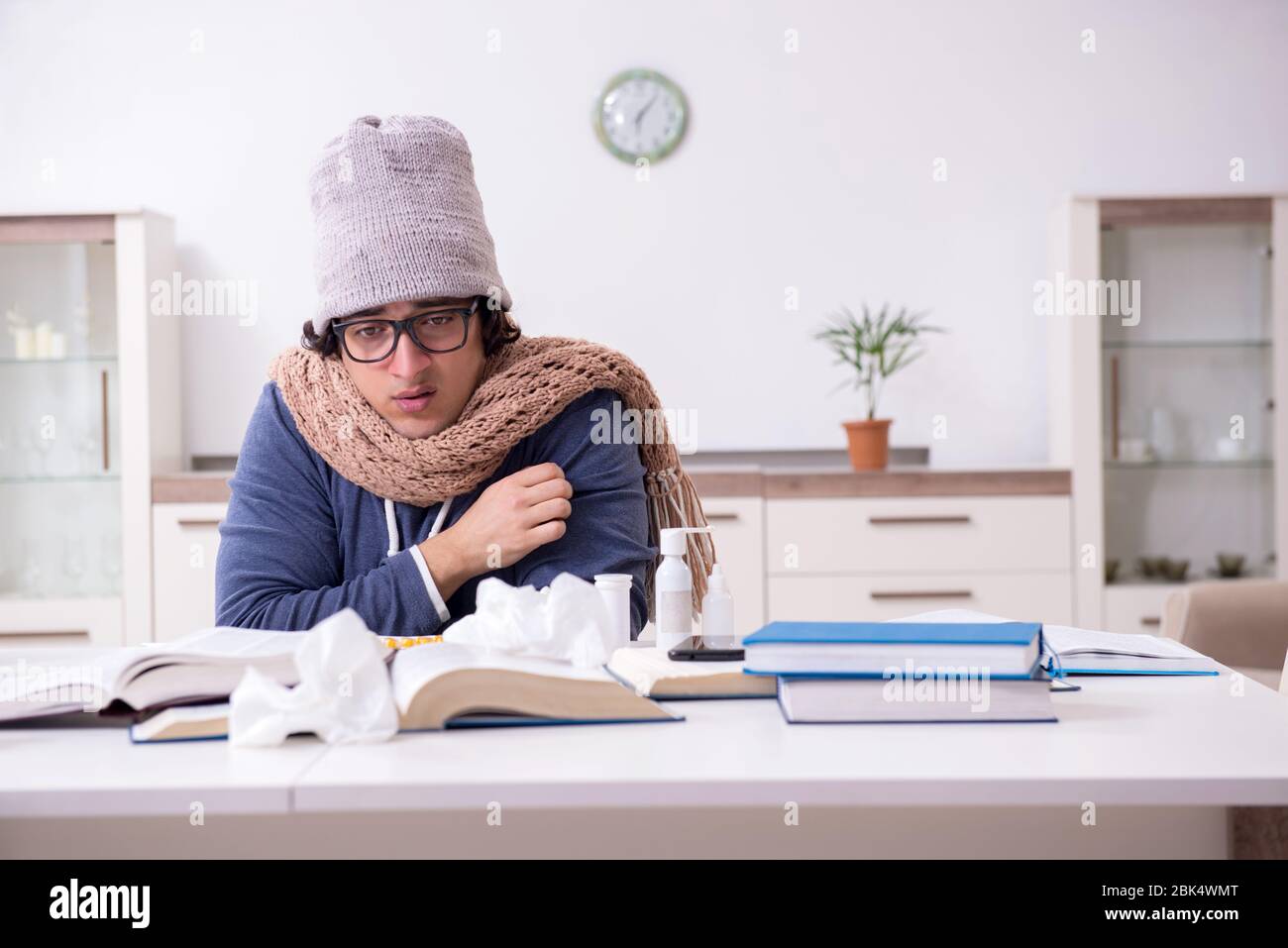 The sick male student suffering at home Stock Photo - Alamy