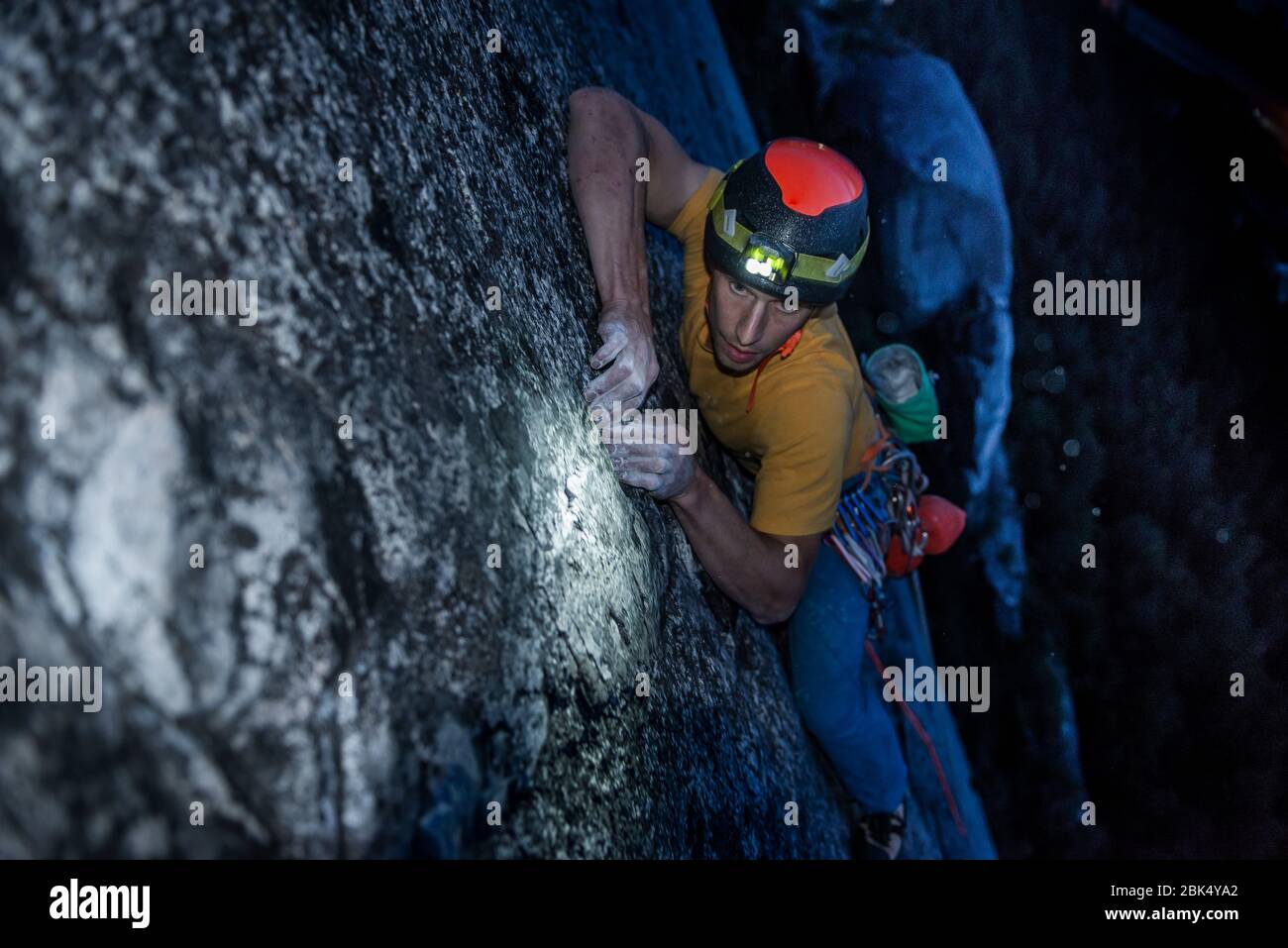 Top view man rock climbing at night above the sea and highway Stock ...