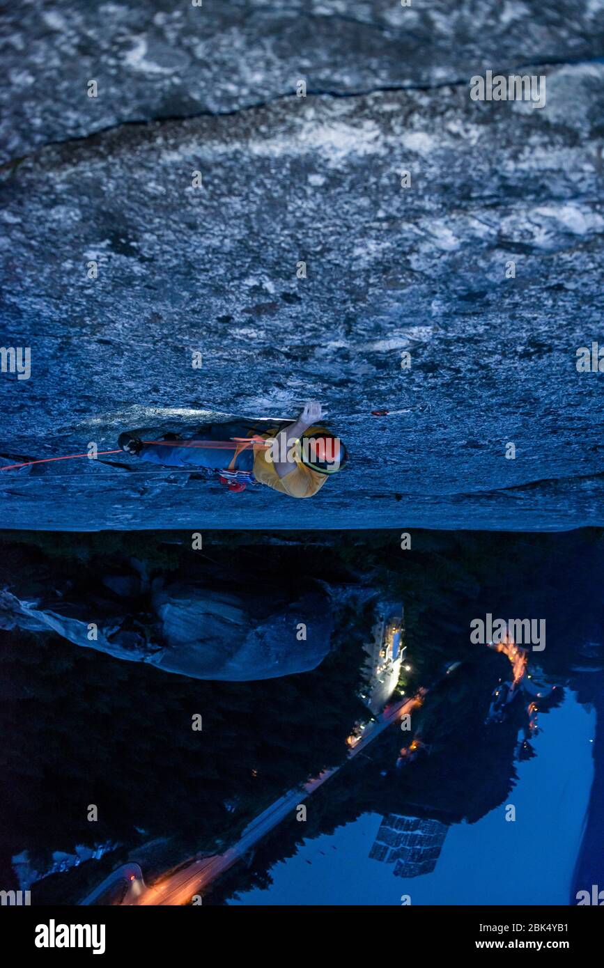 Top view man rock climbing at night above the sea and highway Stock ...