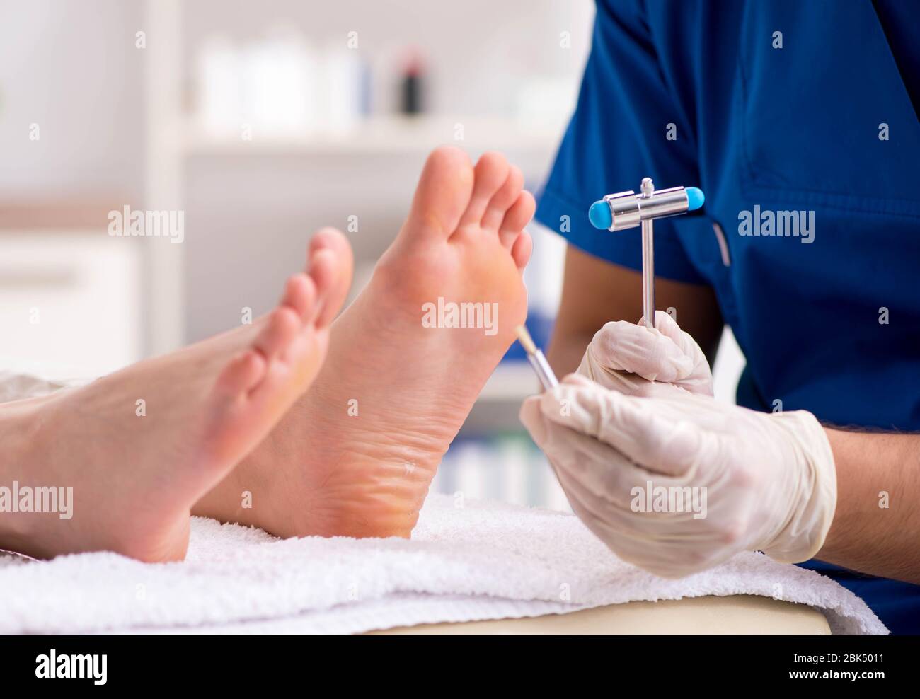 The podiatrist treating feet during procedure Stock Photo - Alamy