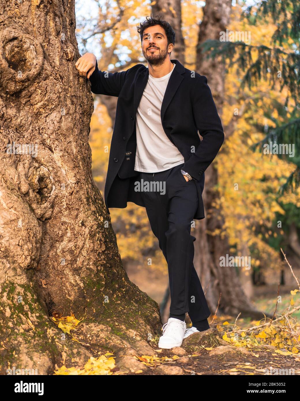 Man pose against tree hi-res stock photography and images - Alamy
