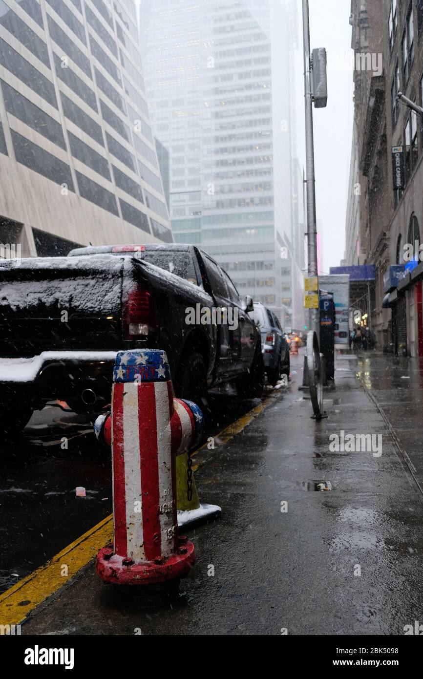 A fire hydrant which is painted with the colours of the United States ...