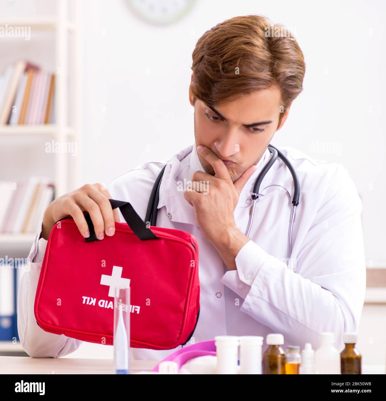 The young doctor with first aid kit in hospital Stock Photo - Alamy