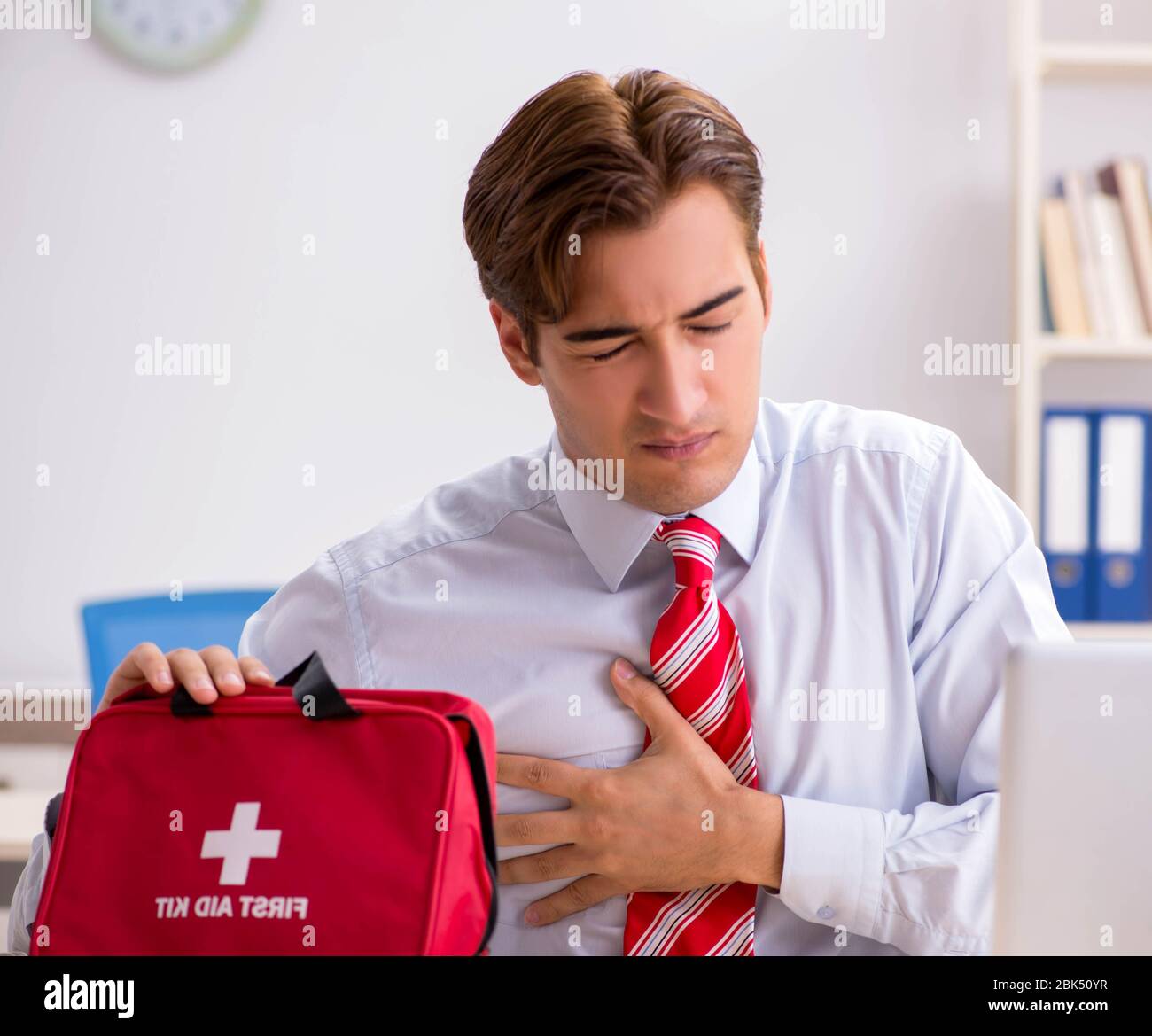 The man with first aid kit in the office Stock Photo - Alamy