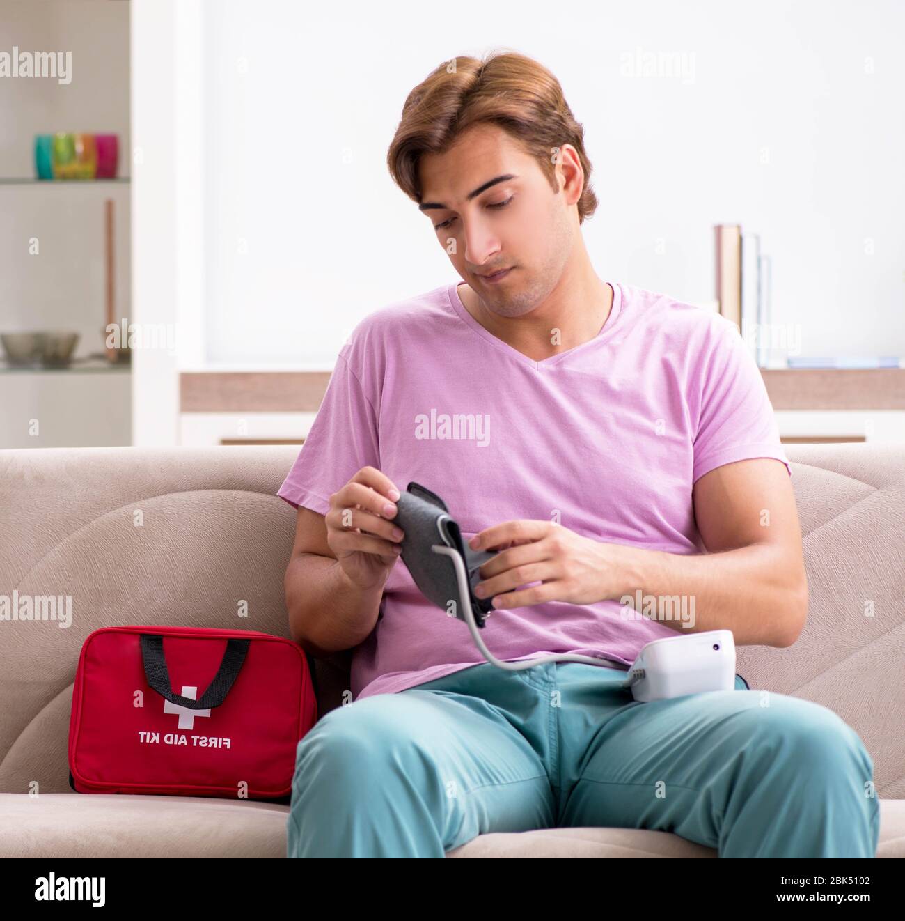 The sick man at home with first aid kit Stock Photo - Alamy