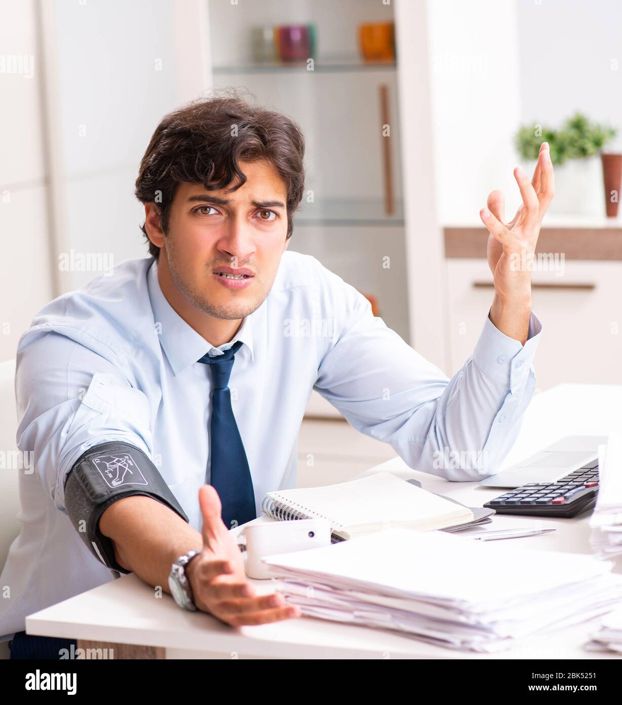 The man under stress measuring his blood pressure Stock Photo - Alamy