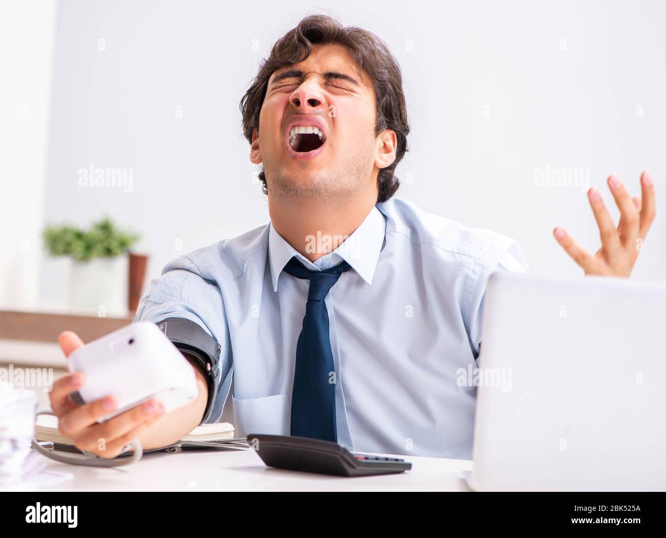 The man under stress measuring his blood pressure Stock Photo - Alamy