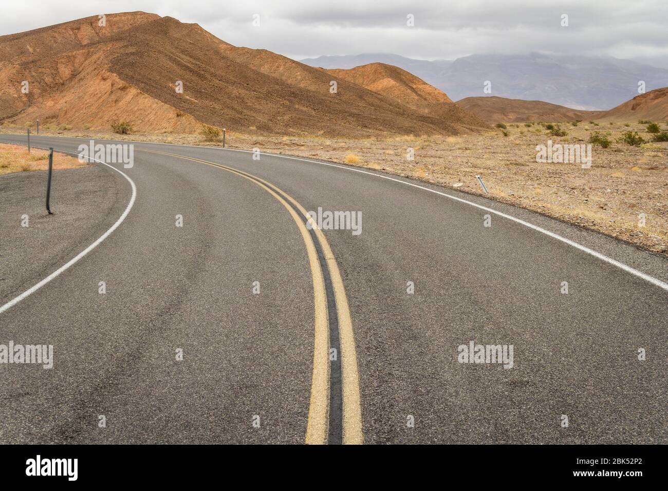 A highway curves through Death Valley National Park, California Stock ...