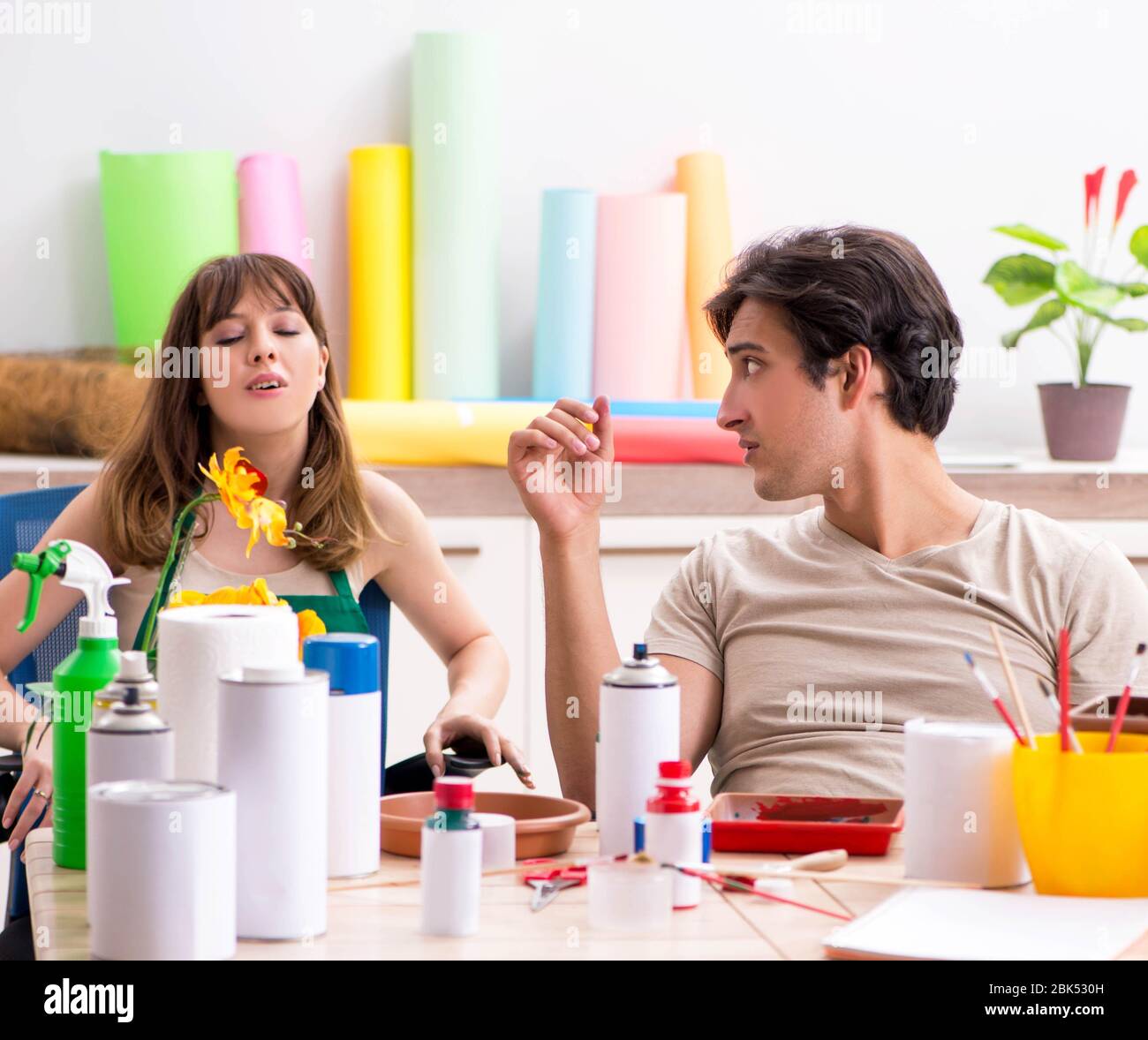 The couple decorating pots in workshop during class Stock Photo - Alamy