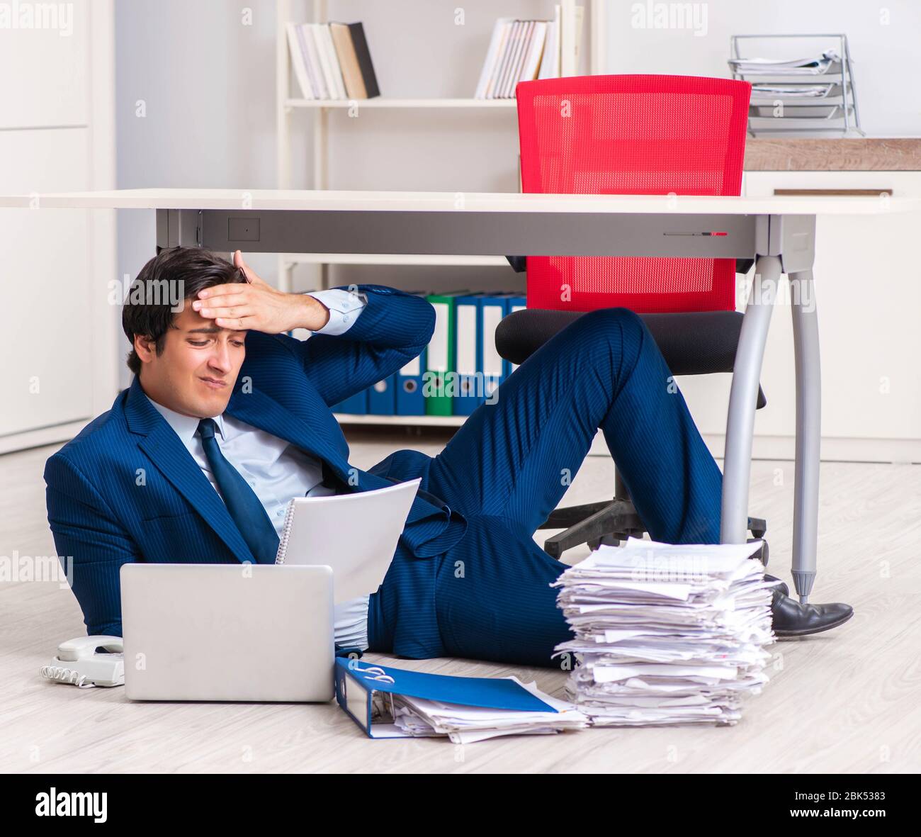 The tired exhausted businessman working overtime in office Stock Photo ...