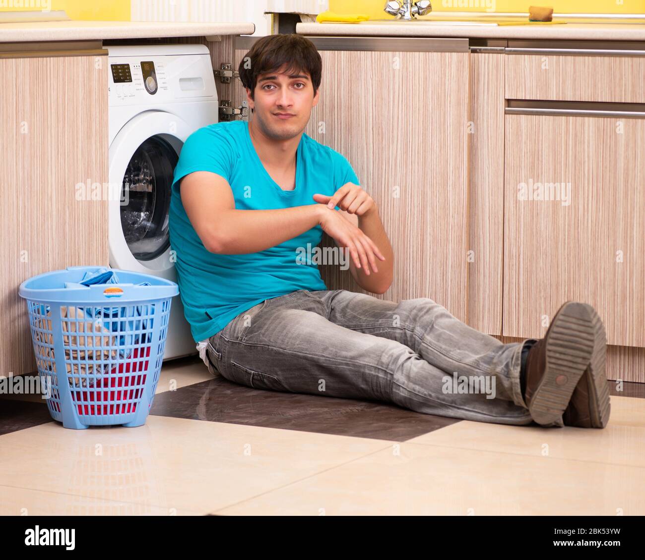 The young husband man doing laundry at home Stock Photo - Alamy