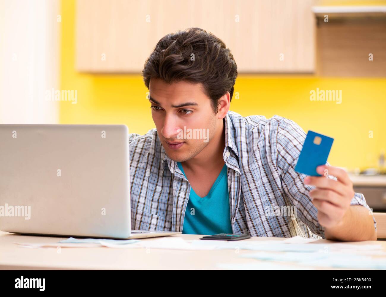 The young man husband in budget planning concept Stock Photo - Alamy