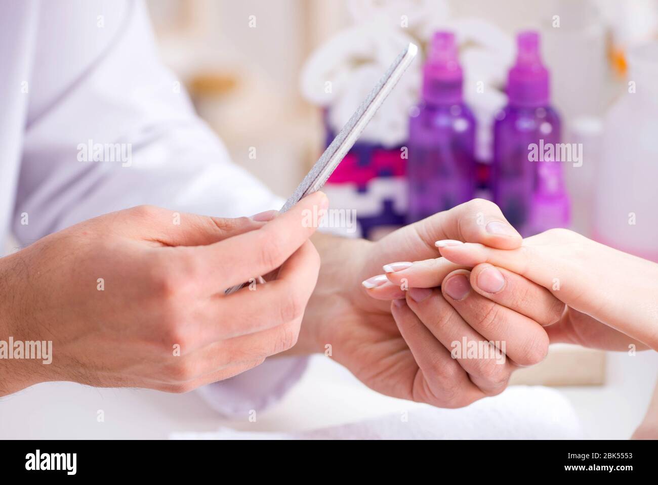 The hands during manicure care session Stock Photo - Alamy