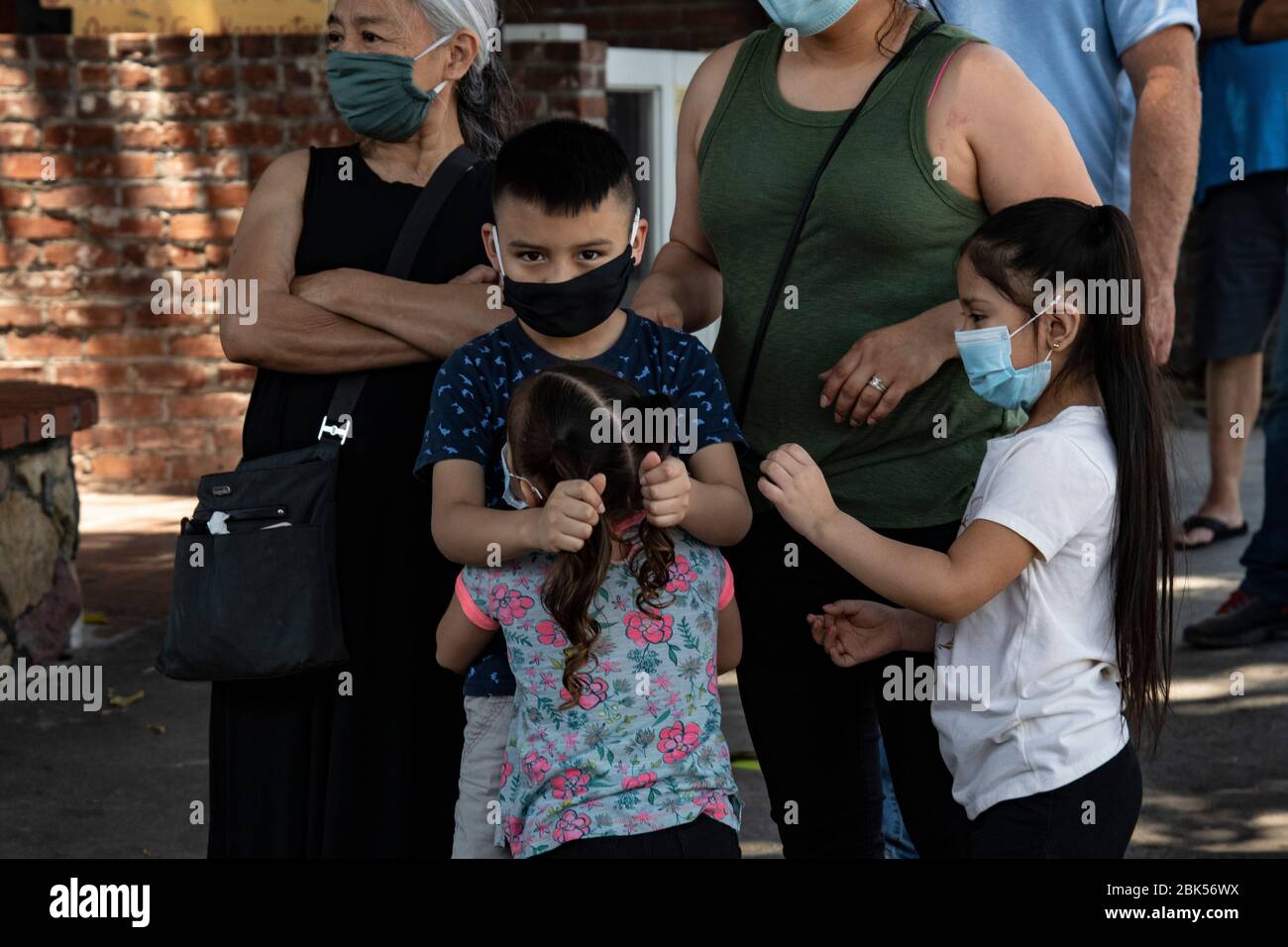 Family together wait in a line outside grocery store Stock Photo - Alamy