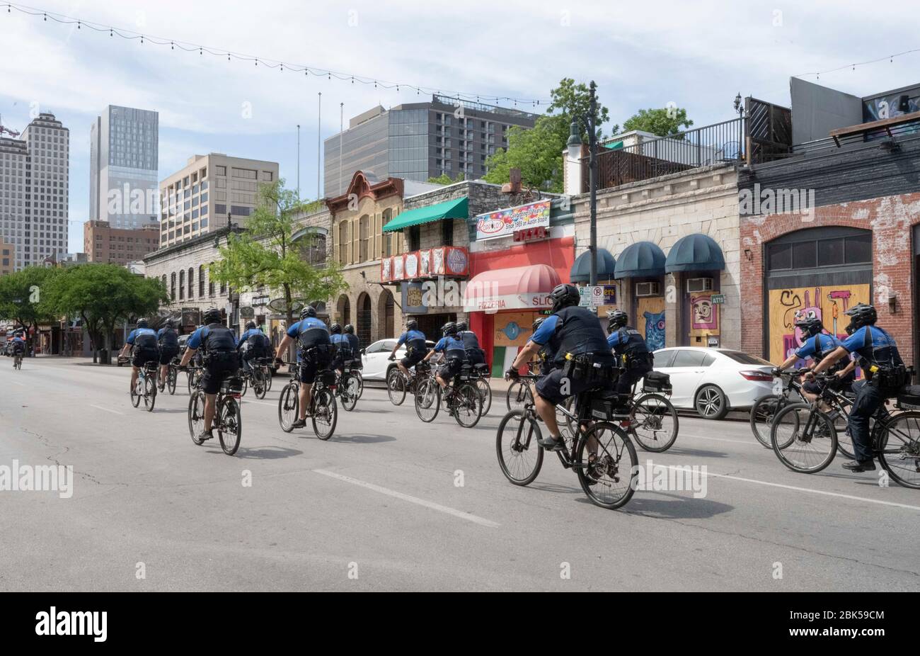 Austin police officers patrol on bicycles on the normally bustling but ...