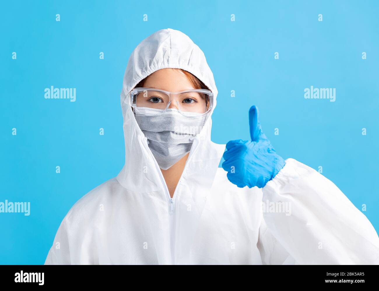 female nurse wearing medical mask with safety glasses and in white ...